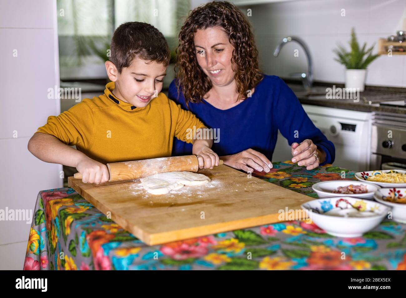 Mother and son making dough to make a pizza Stock Photo - Alamy