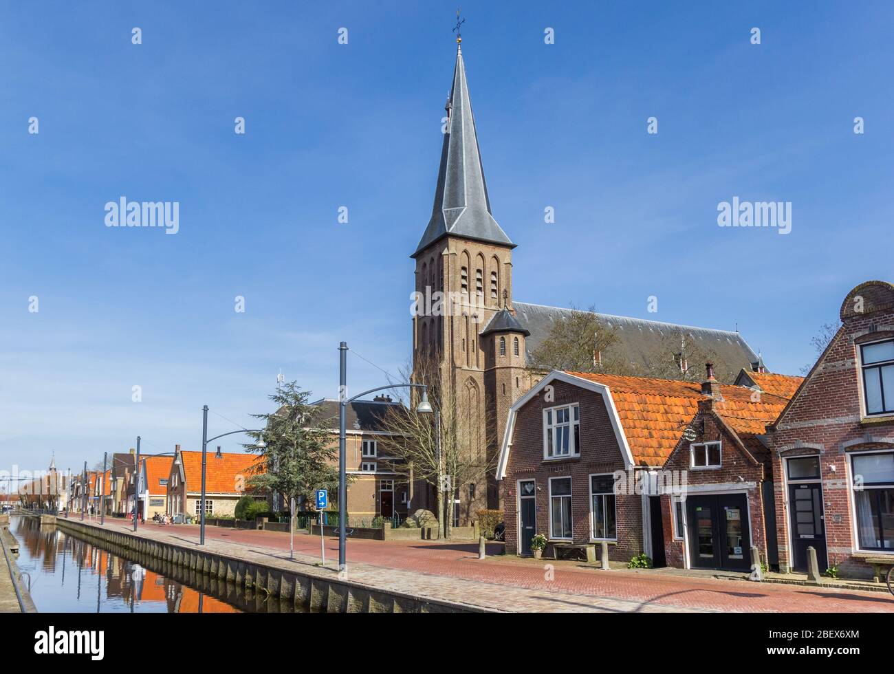 Historic catholic church at the canal in Balk, Netherlands Stock Photo ...