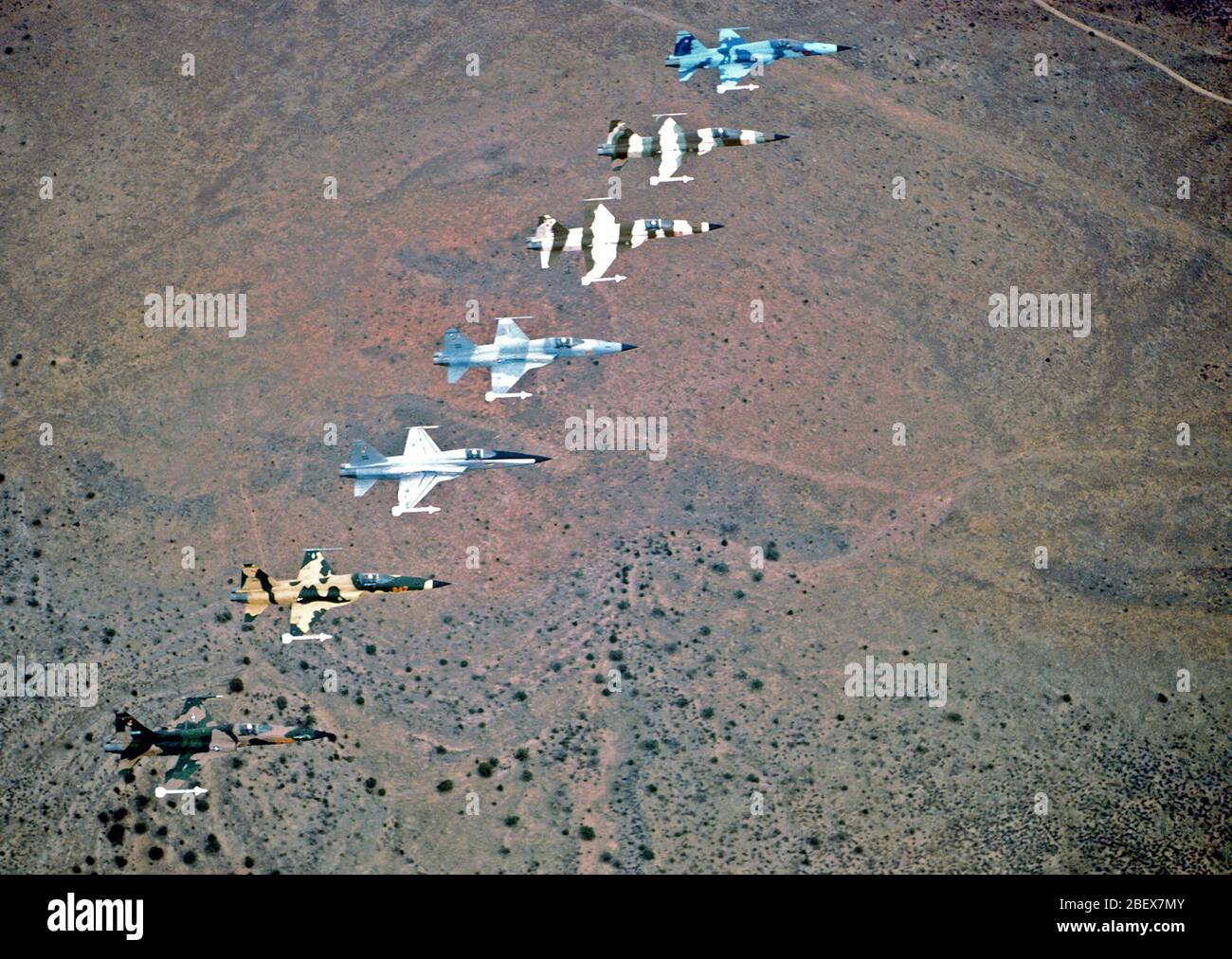 1981 - An air-to-air overhead view of a seven-ship echelon formation of ...