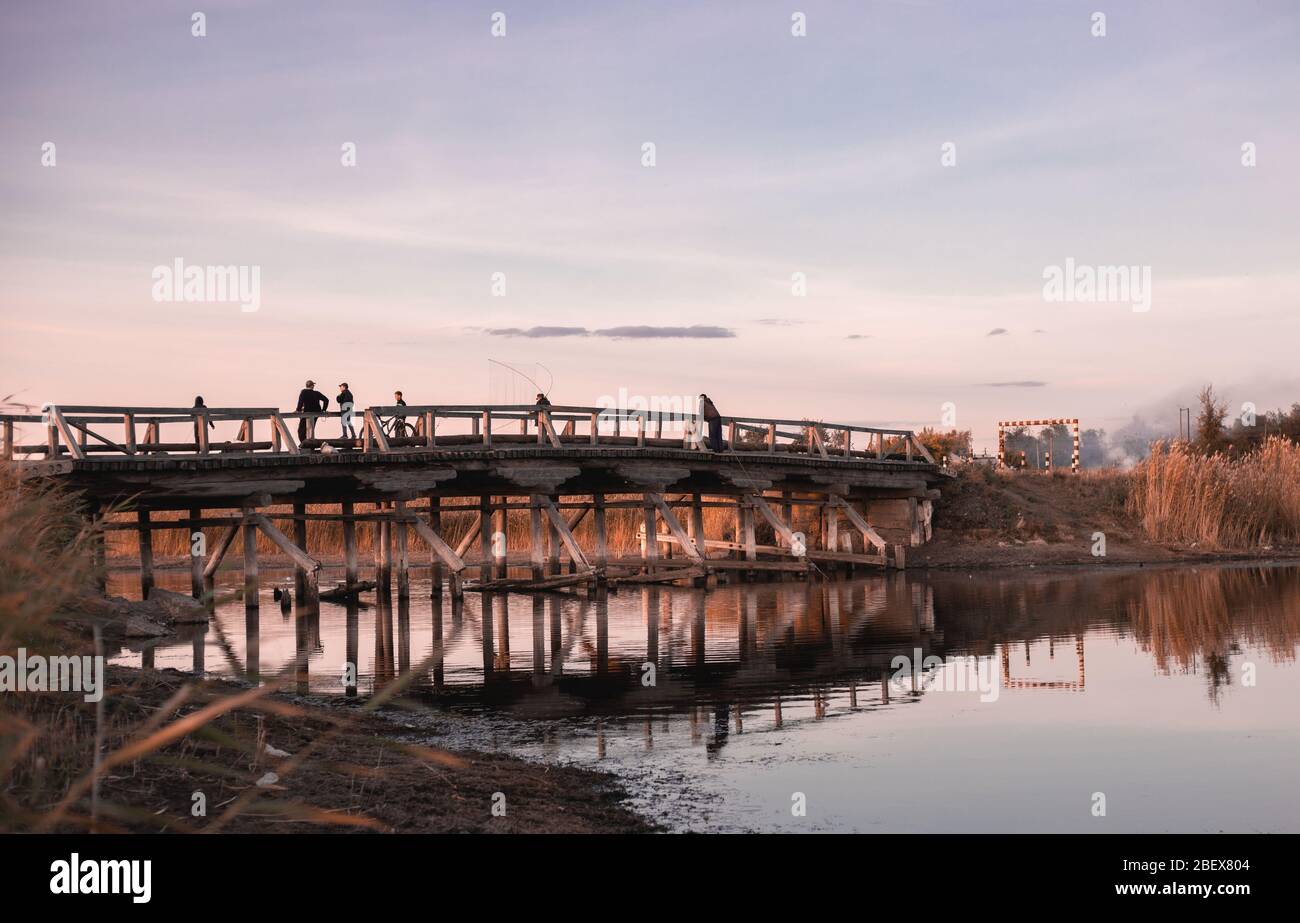 People on the bridge at sunset Stock Photo - Alamy