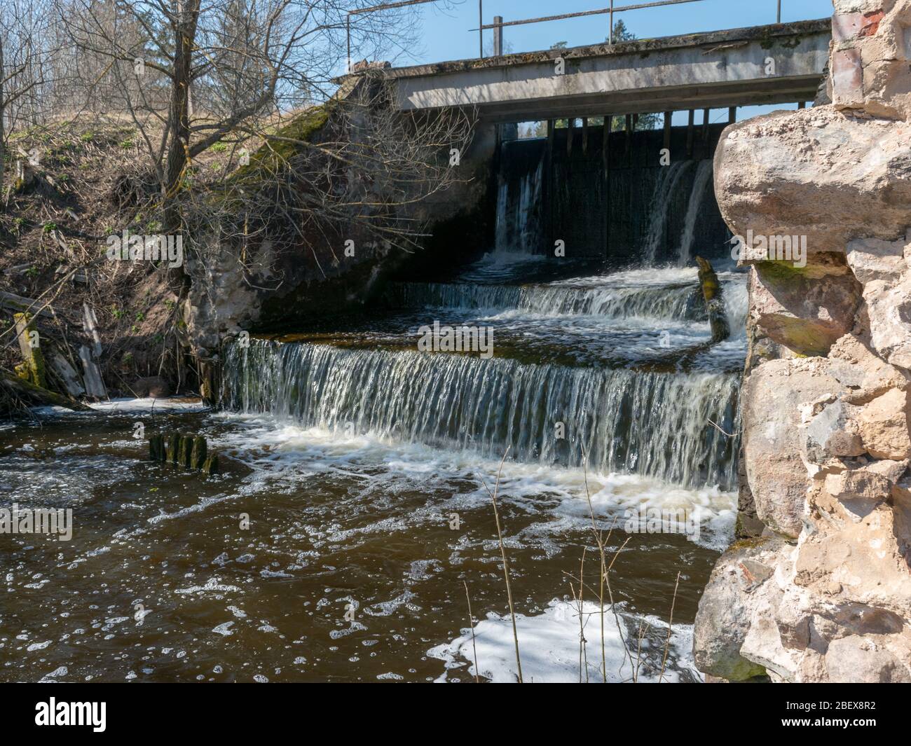colorful view of running water from the mill dam Stock Photo - Alamy