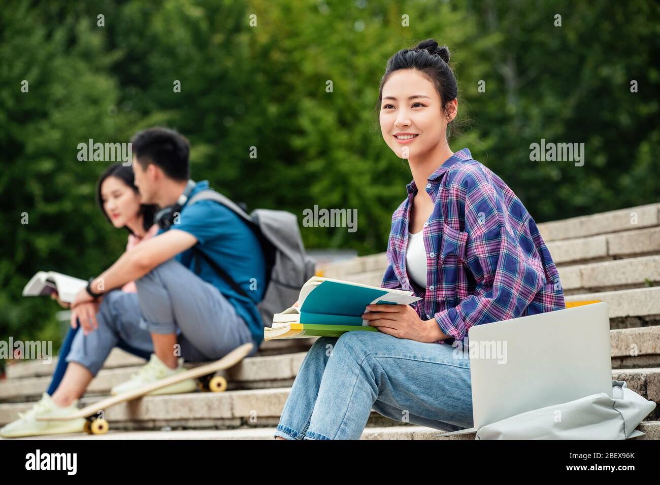 Happy college students sat on the steps of learning Stock Photo - Alamy