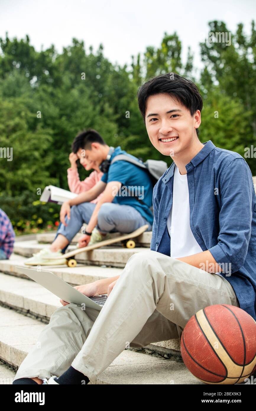 Happy college students sat on the steps of learning Stock Photo - Alamy