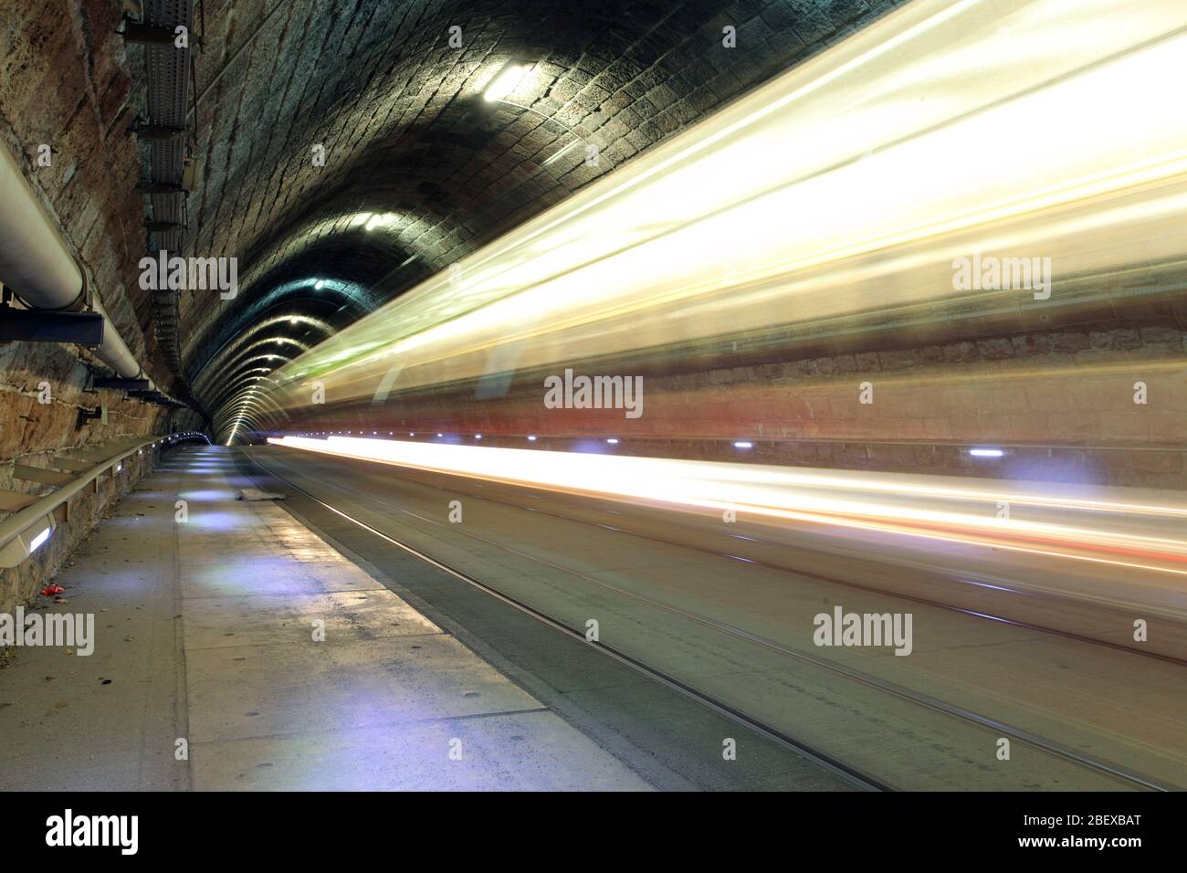 Underground railroad with moving train, transporation Stock Photo - Alamy