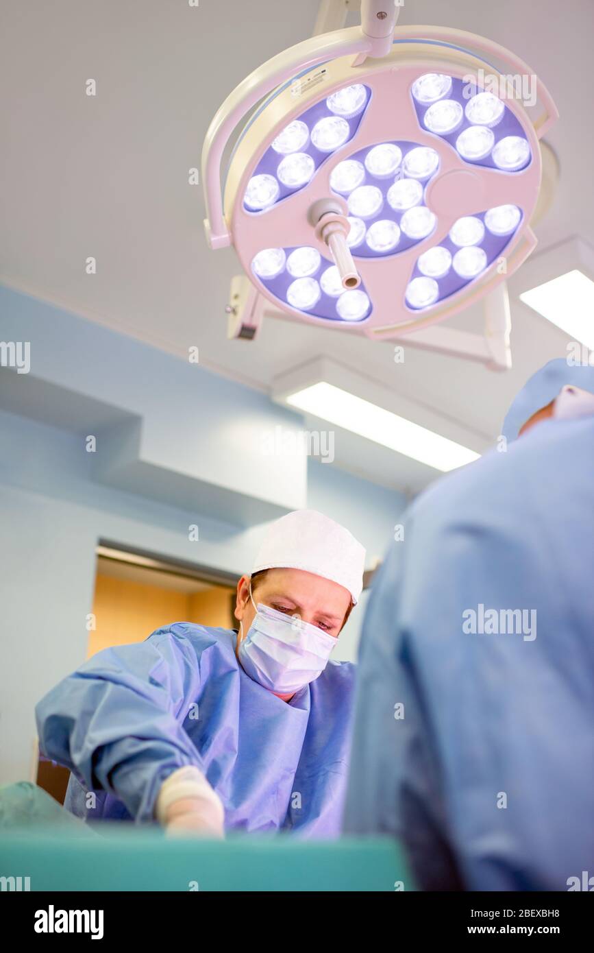 Medical professional in an operating room performing medical procedure ...