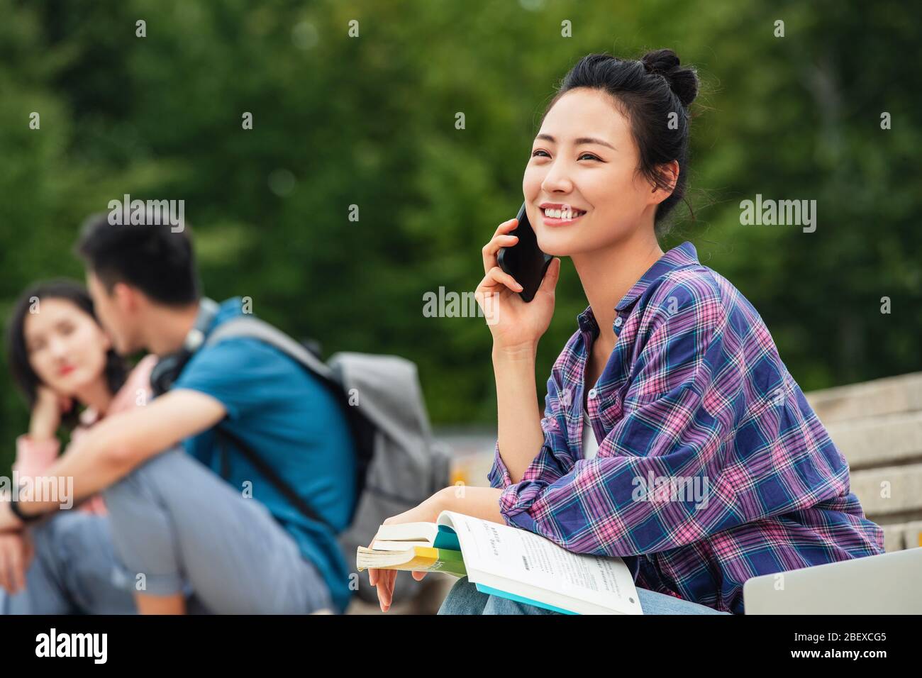 Happy college students sat on the steps of a call Stock Photo - Alamy