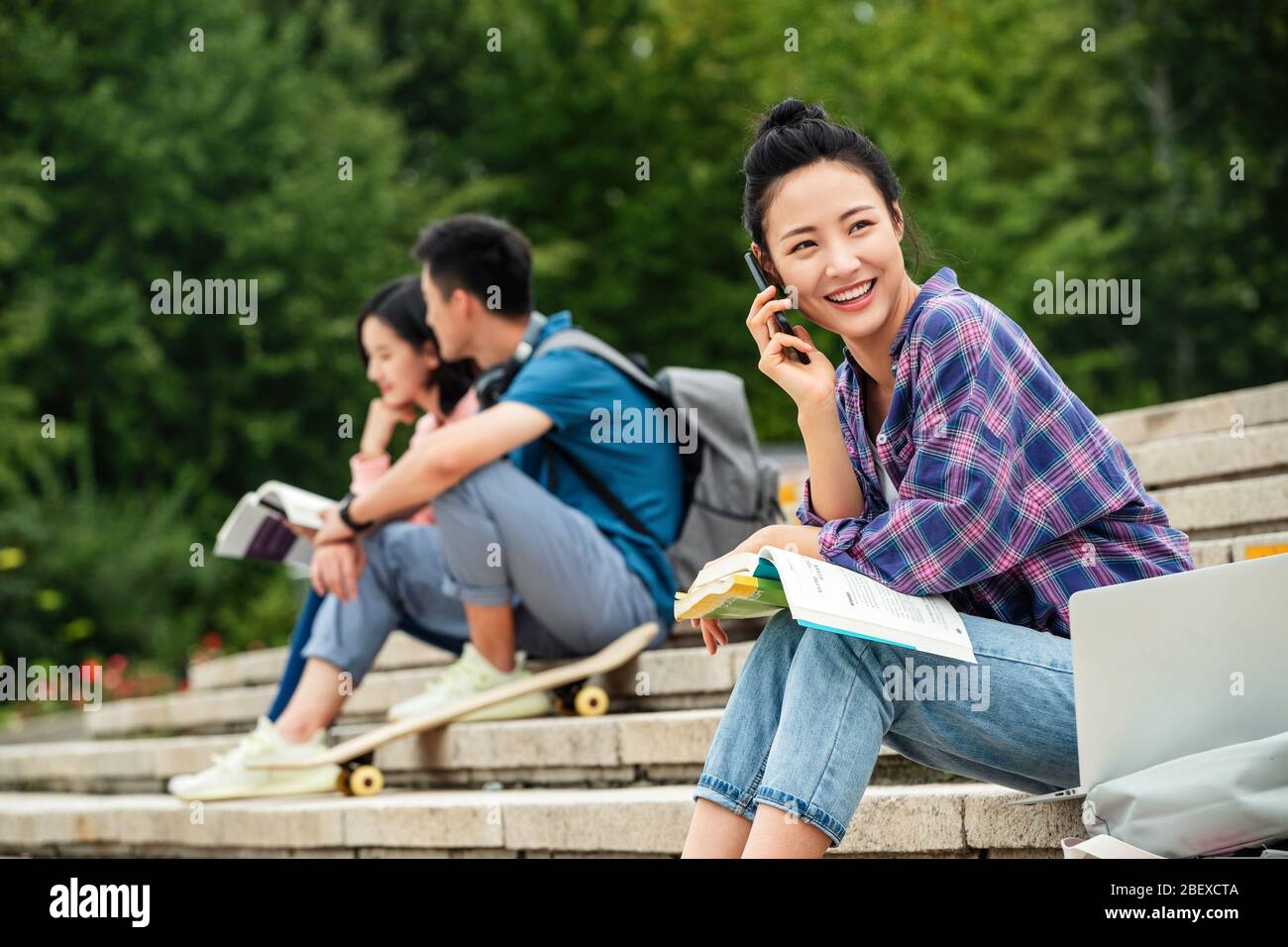 Happy college students sat on the steps of a call Stock Photo - Alamy