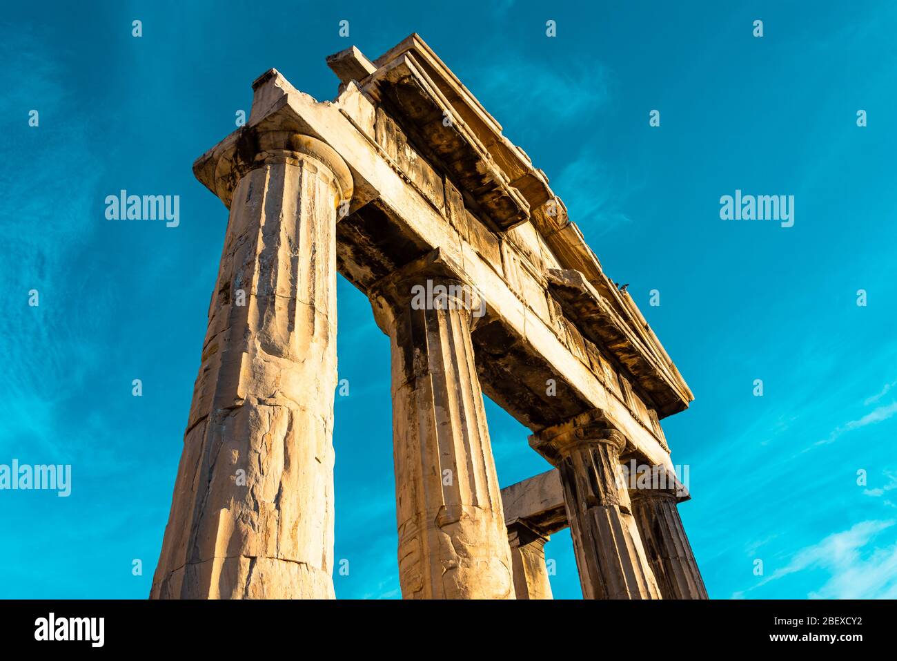 Low angle view of a Greek arch isolated on plain blue sky, Athens ...