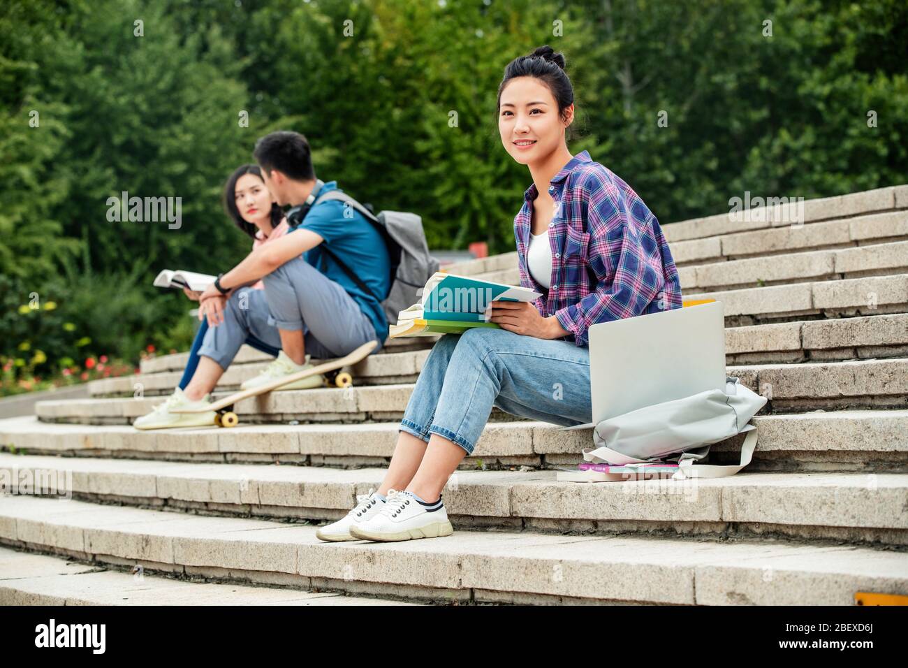 Happy college students sat on the steps of learning Stock Photo - Alamy