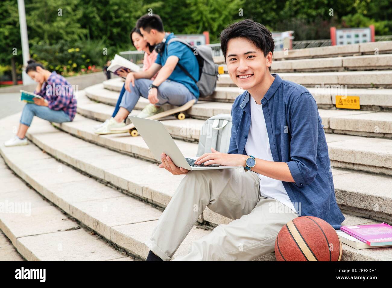 Happy college students sat on the steps of learning Stock Photo - Alamy