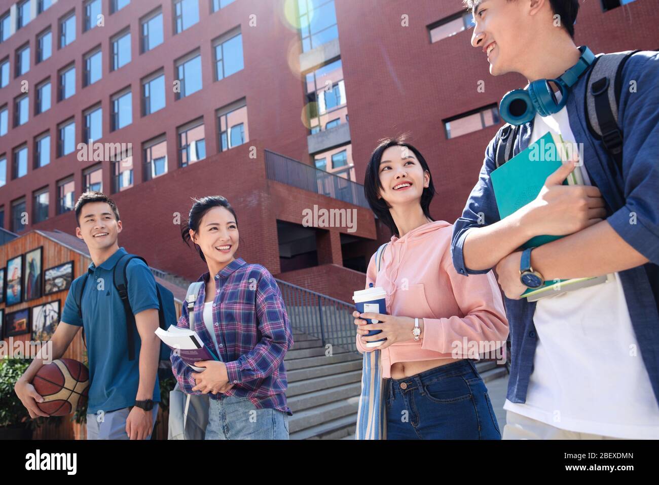 Two couple prepared to go to class on the campus of university students ...