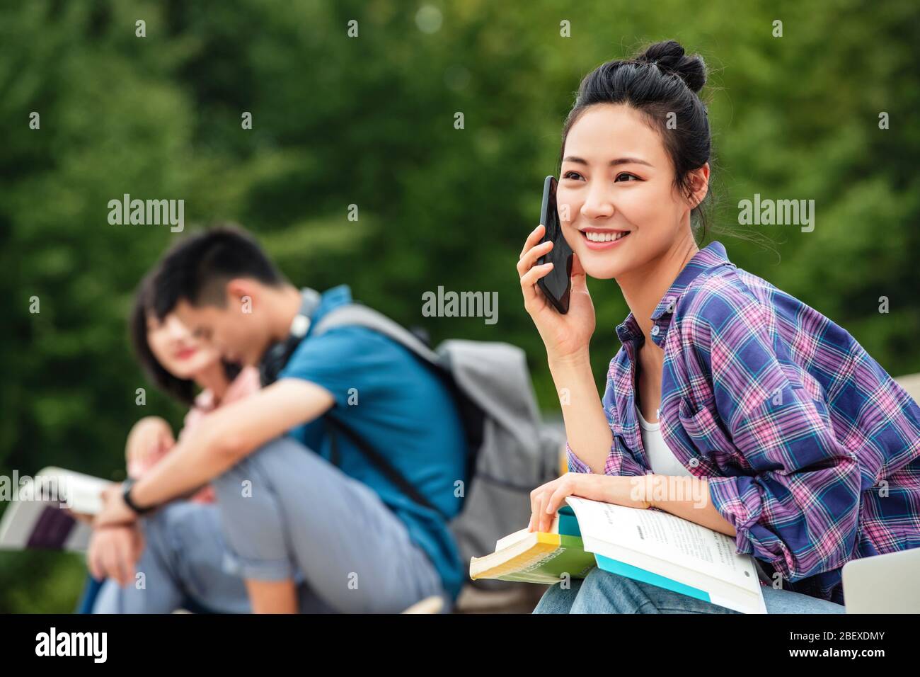Happy college students sat on the steps of a call Stock Photo - Alamy