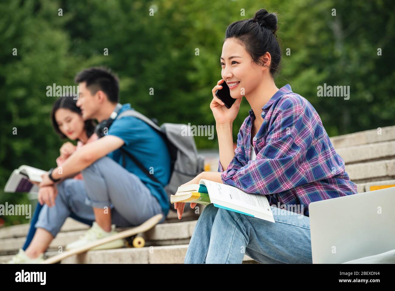 Happy college students sat on the steps of a call Stock Photo - Alamy