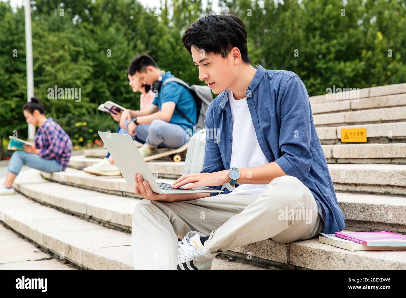 Happy college students sat on the steps of learning Stock Photo - Alamy