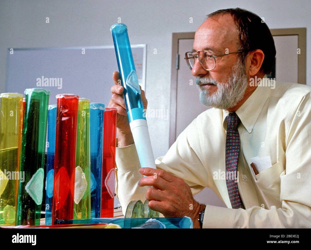 Scientist examining beakers ca. 1996 Stock Photo - Alamy