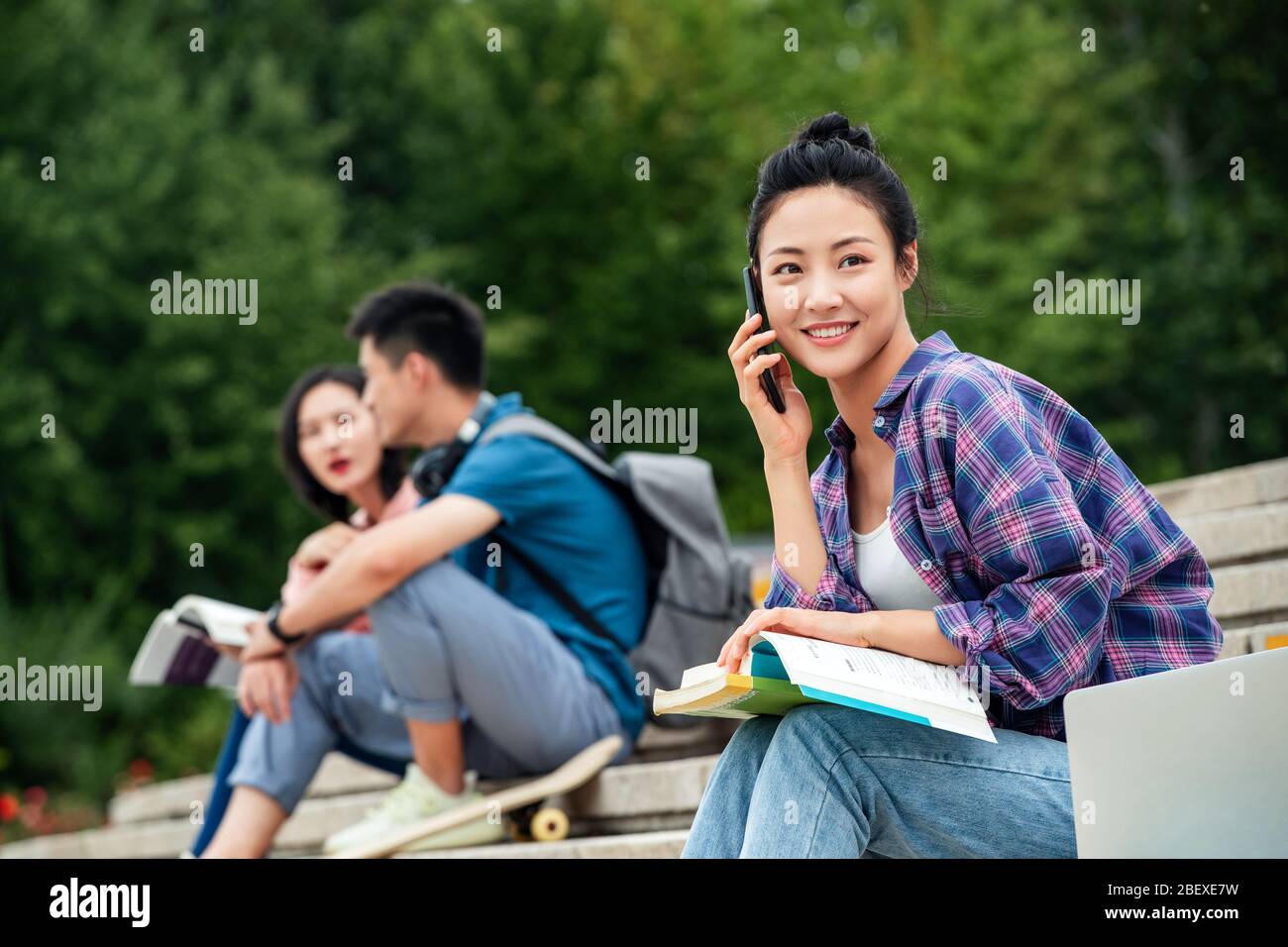 Happy college students sat on the steps of a call Stock Photo - Alamy