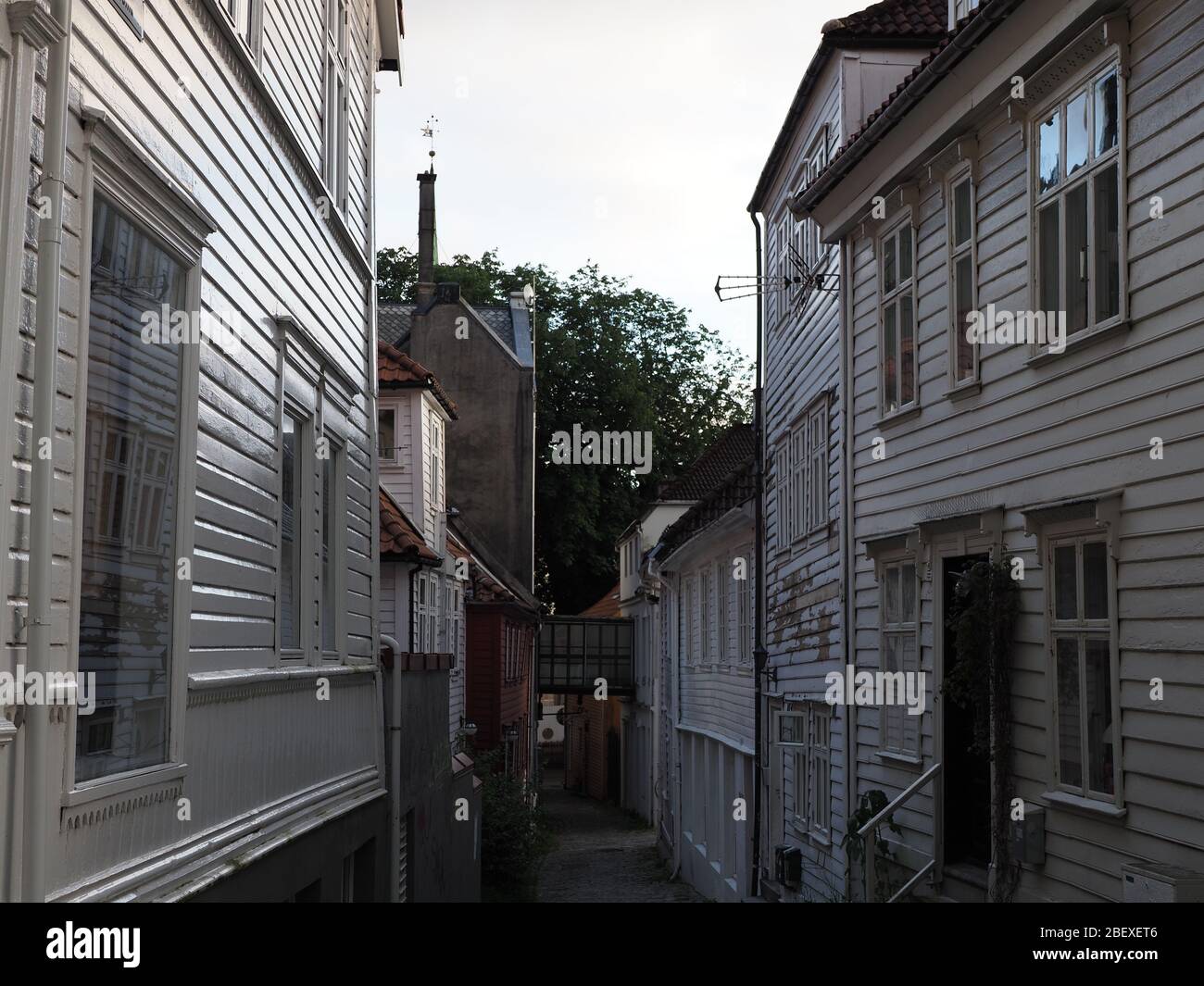 Narrow alley with white houses of european Bergen town in Norway Stock ...