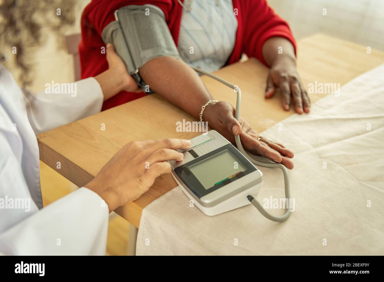 Nurse checking blood pressure hi-res stock photography and images - Alamy