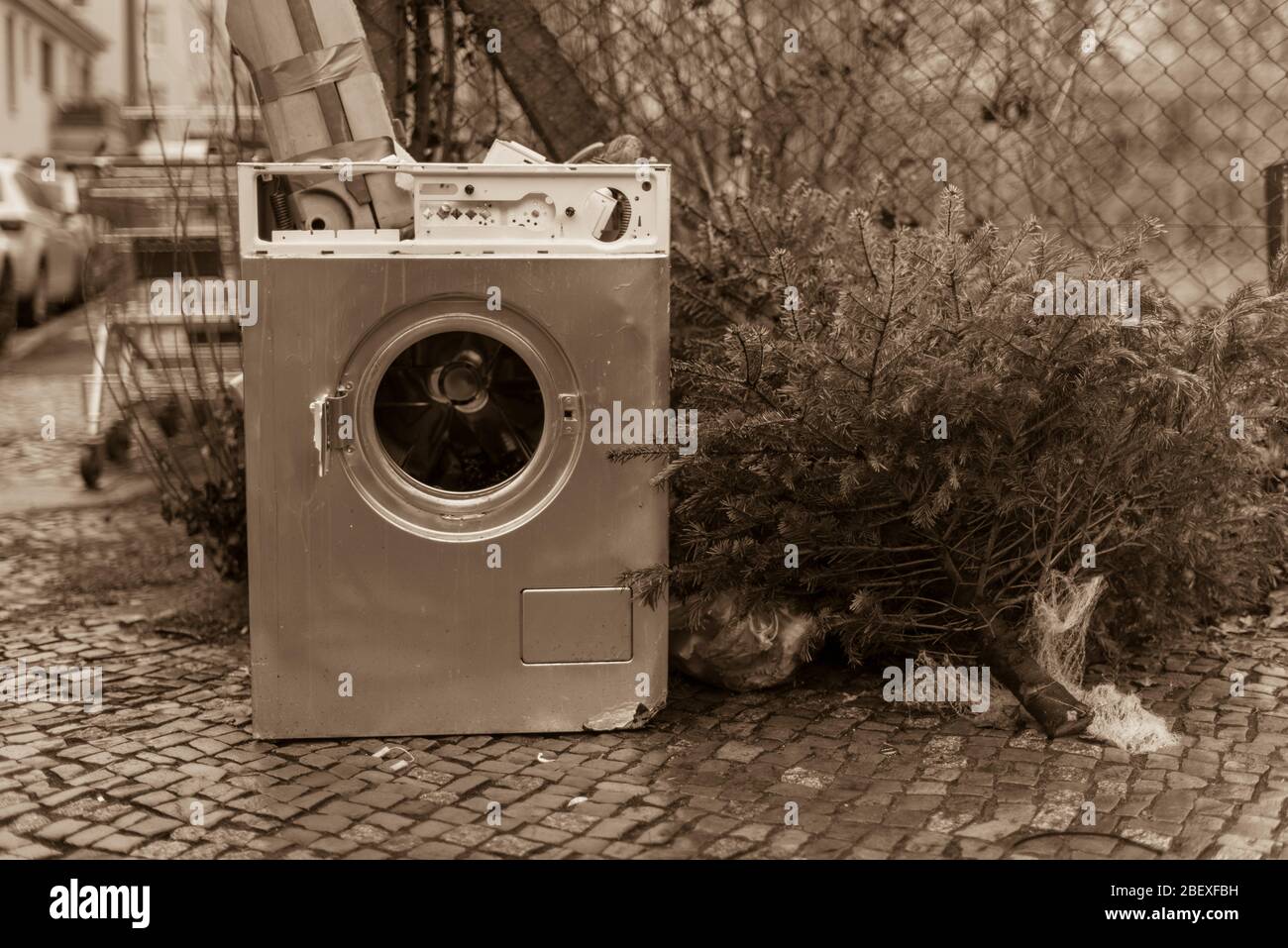 Old washing machine standing on the sidewalk, junk on the street ...