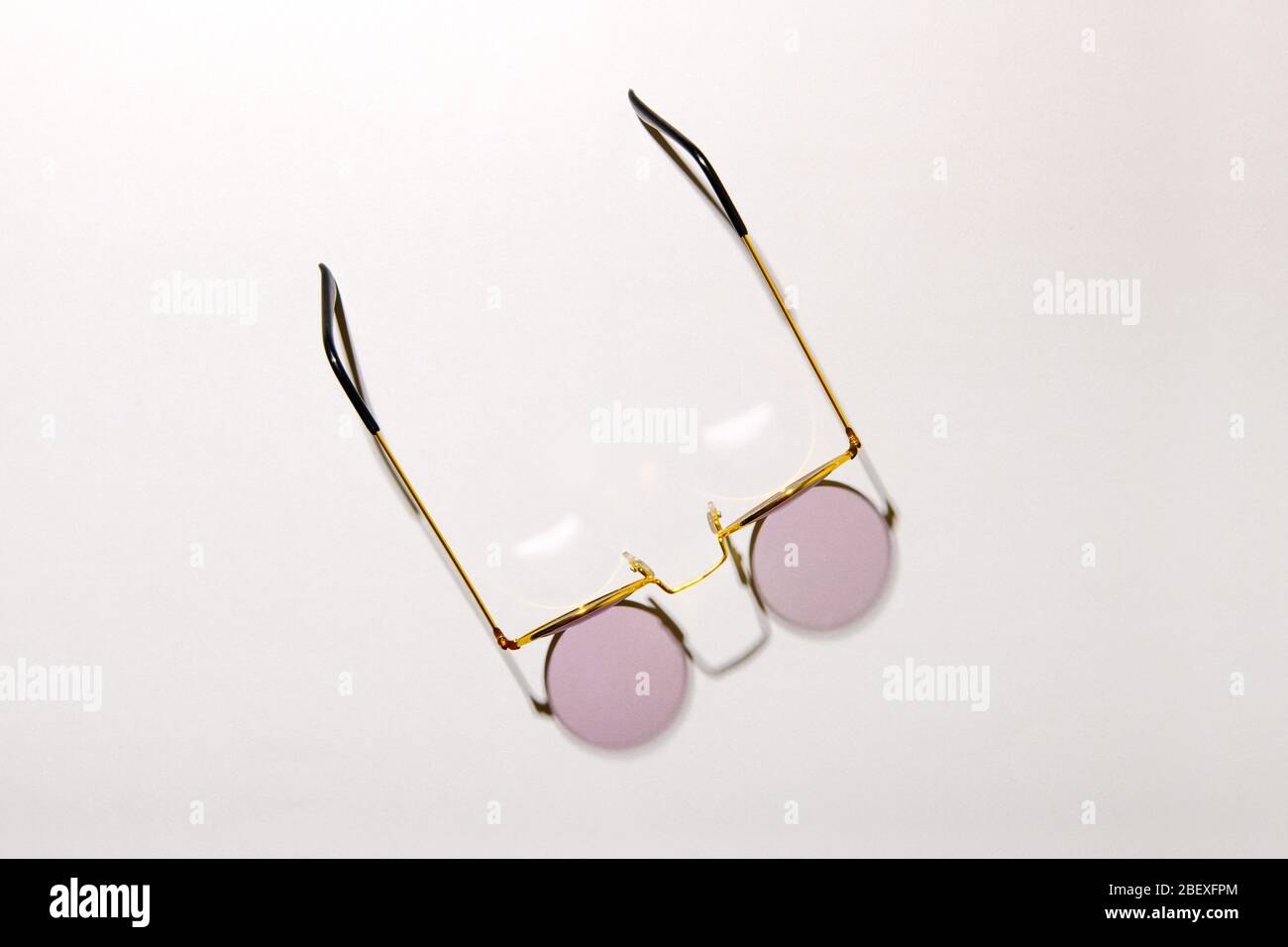 Wire rimmed sunglasses or shades viewed top down with shadow of the ...