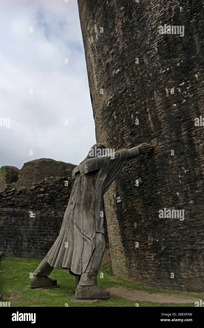 Status holding leaning tower inside Caerphilly Castle Stock Photo - Alamy