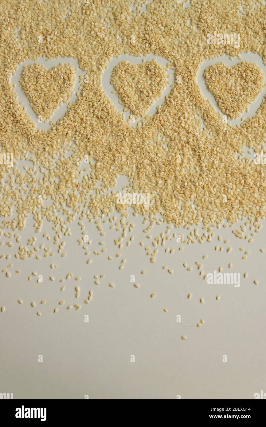 Close up view of dry sesame seeds on white background. Natural oil-rich ...
