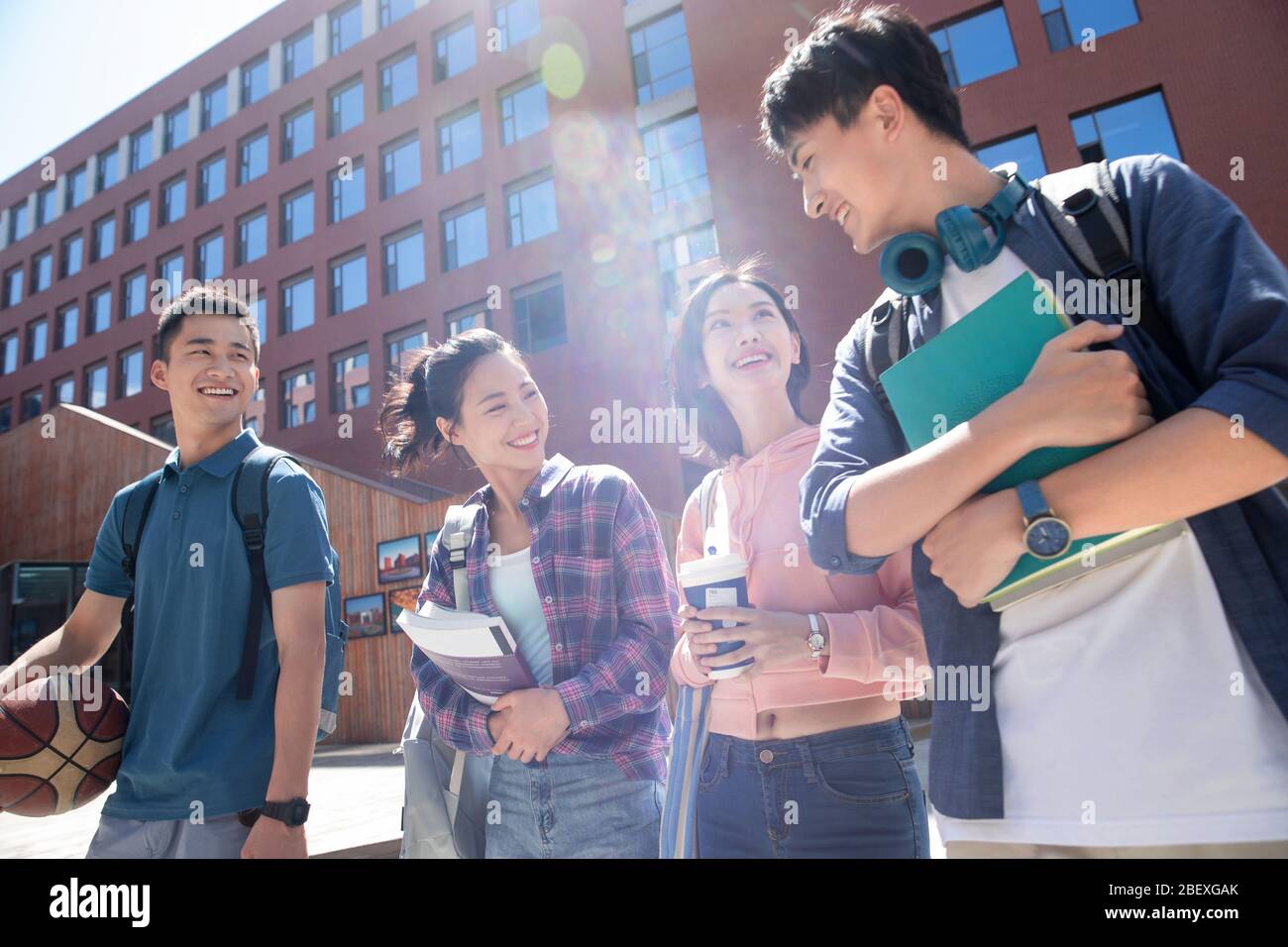 The sunshine walked four college students on campus and talk Stock ...