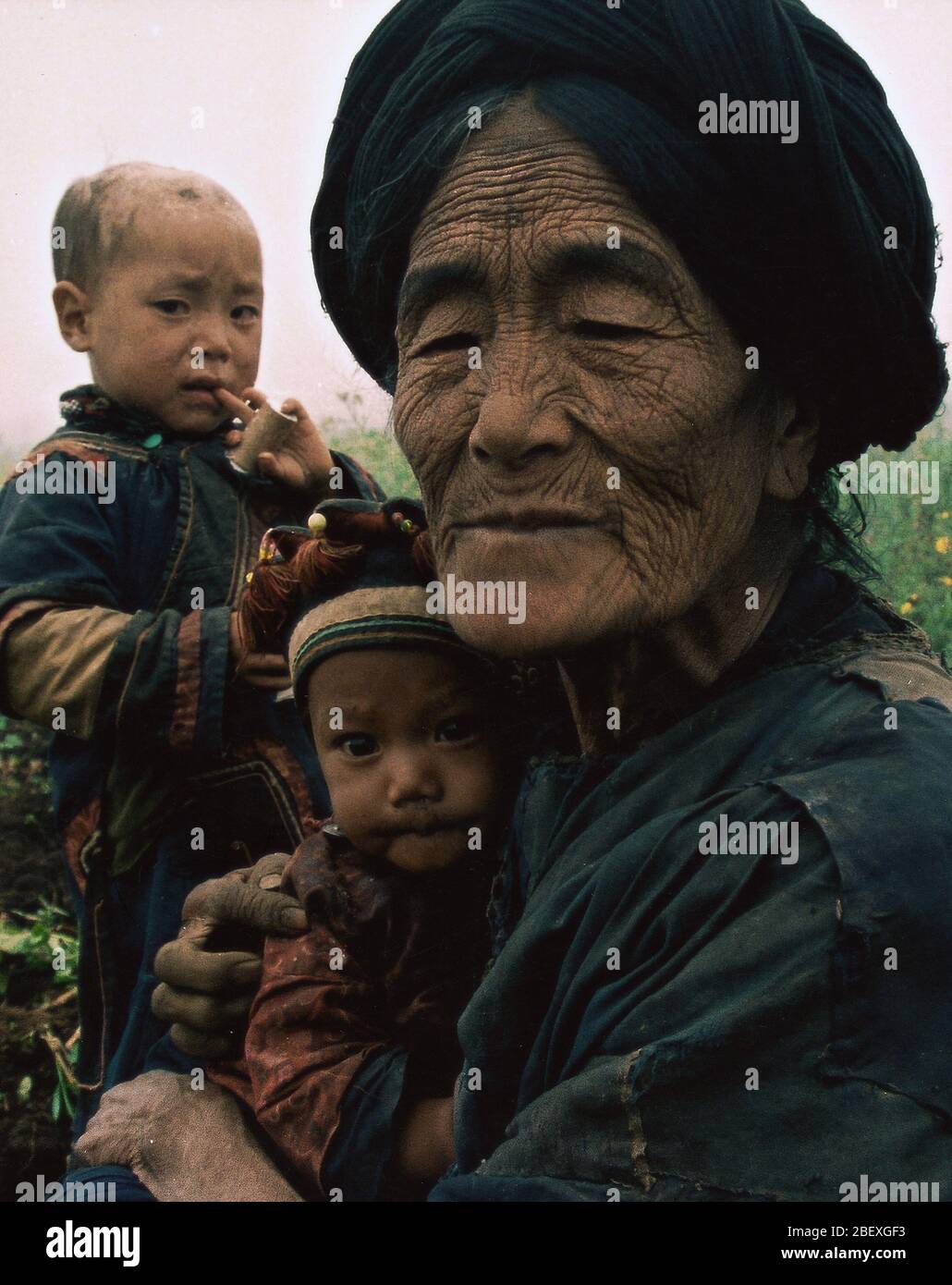 Old man and child at a funeral of a tribal leader of the Yi tribe in ...