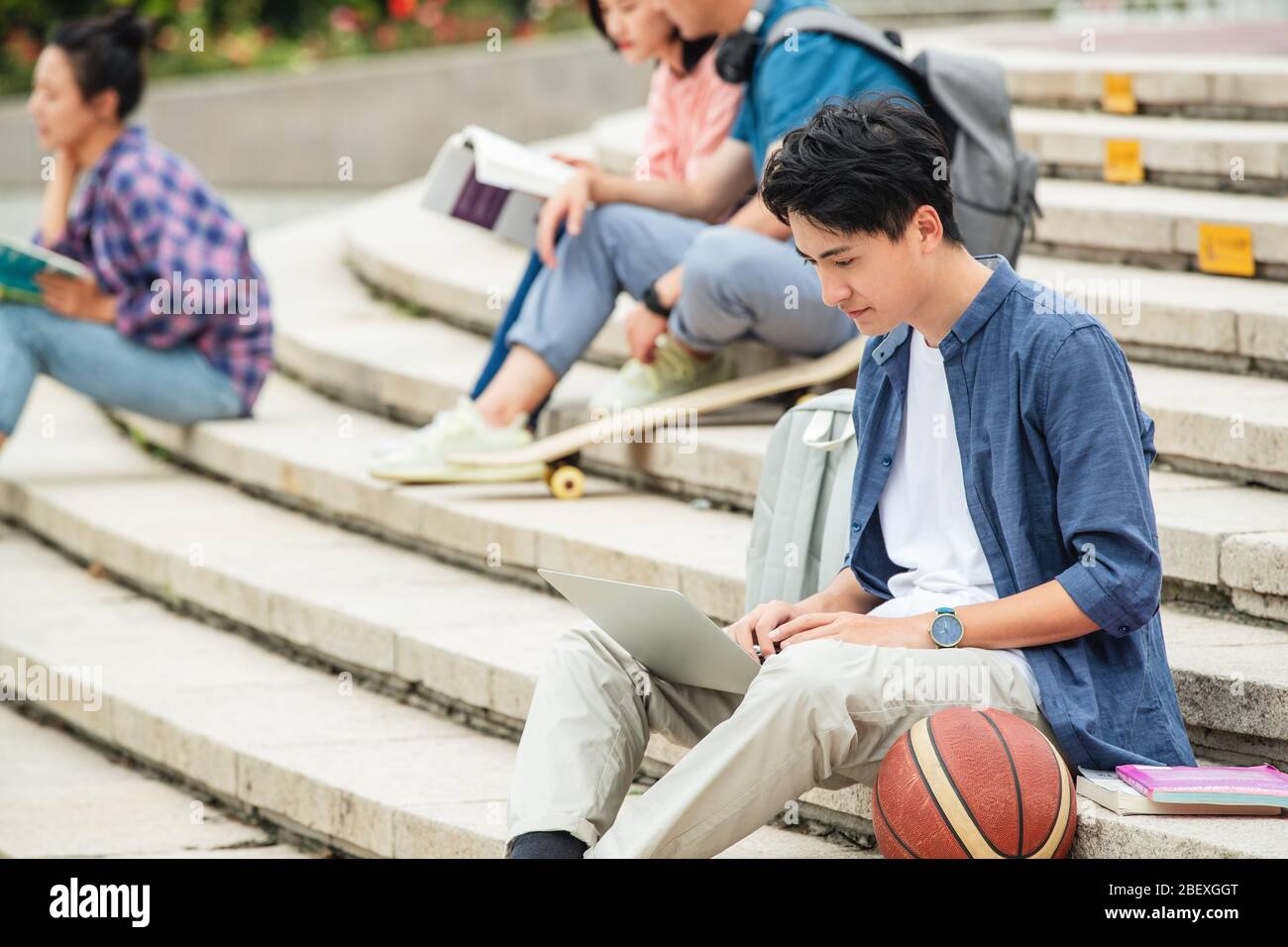 Happy college students sat on the steps of learning Stock Photo - Alamy