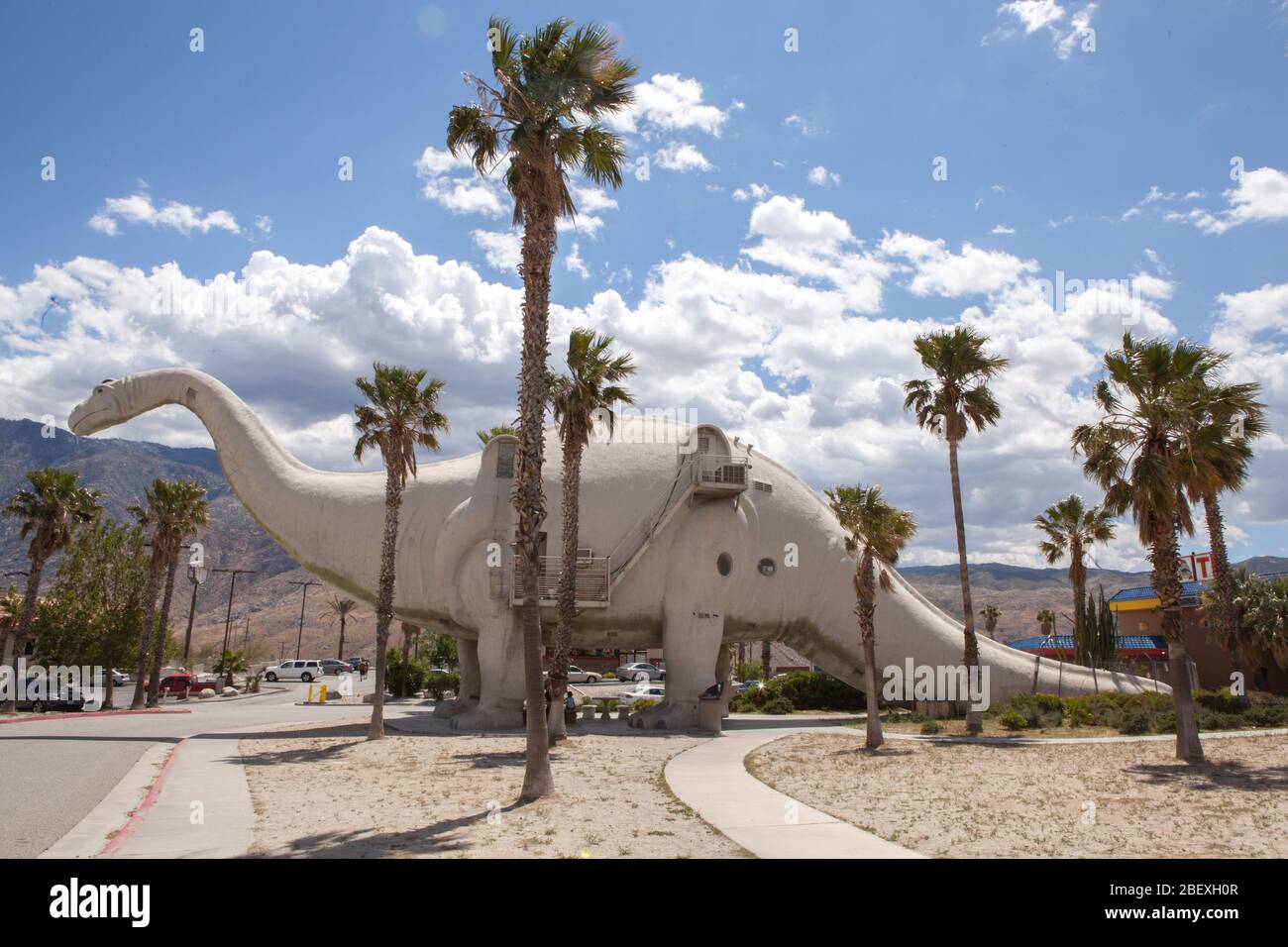 Dinny the Dinosaur at Cabazon Dinosaurs with palm trees Stock Photo - Alamy