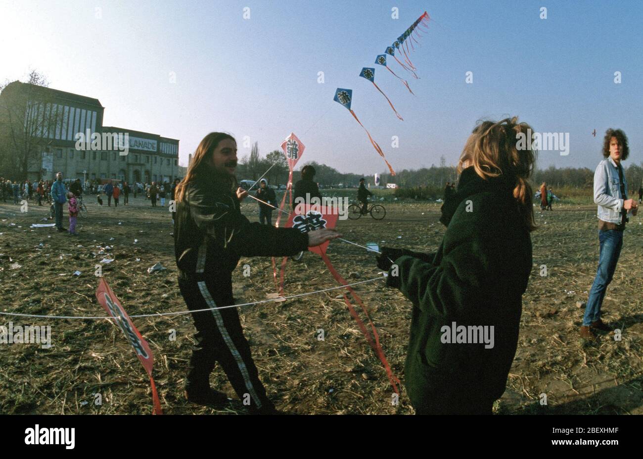 East Germans fly kites as they celebrate the demolition of a section of ...