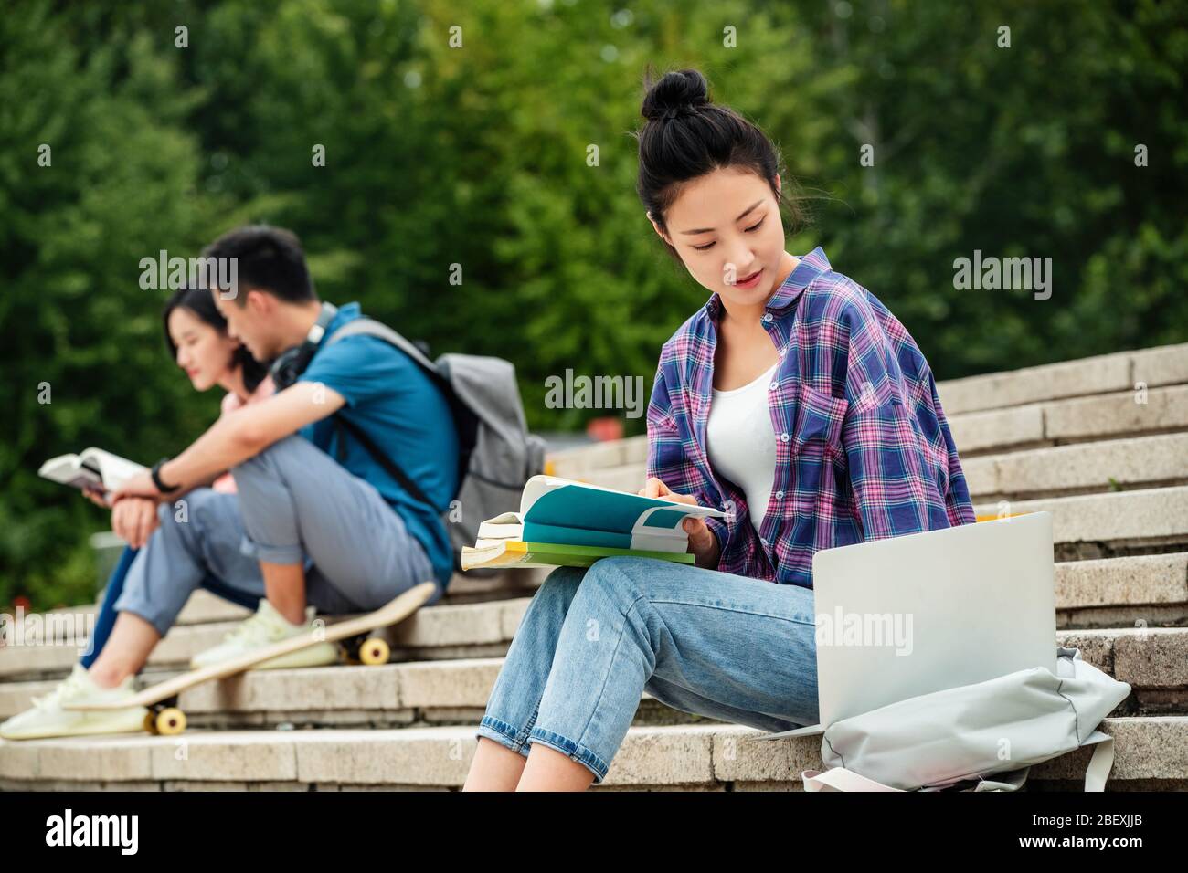 Happy college students sat on the steps of learning Stock Photo - Alamy