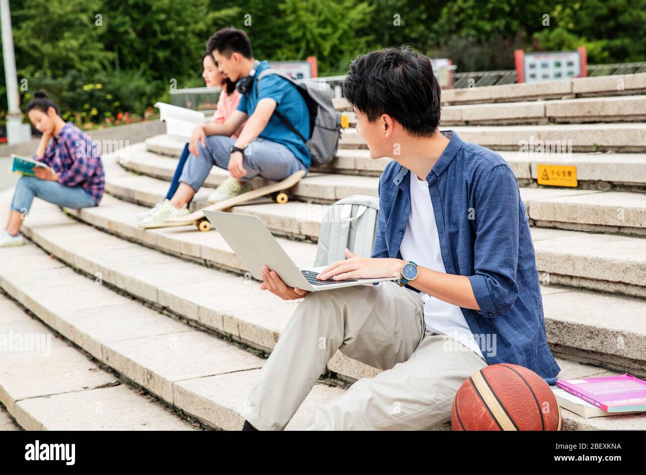 Happy college students sat on the steps of learning Stock Photo - Alamy