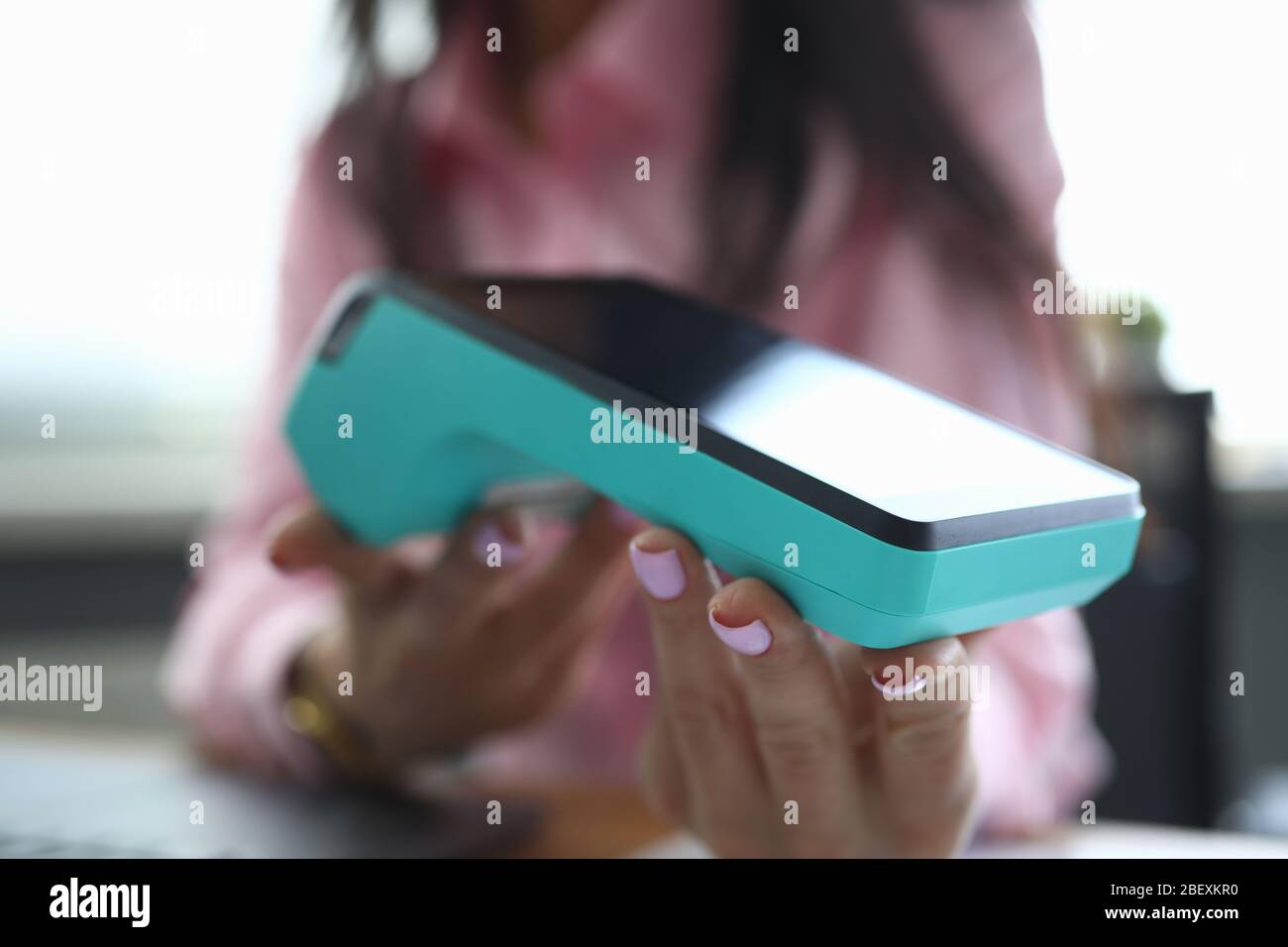 Worker helping pay credit card Stock Photo - Alamy