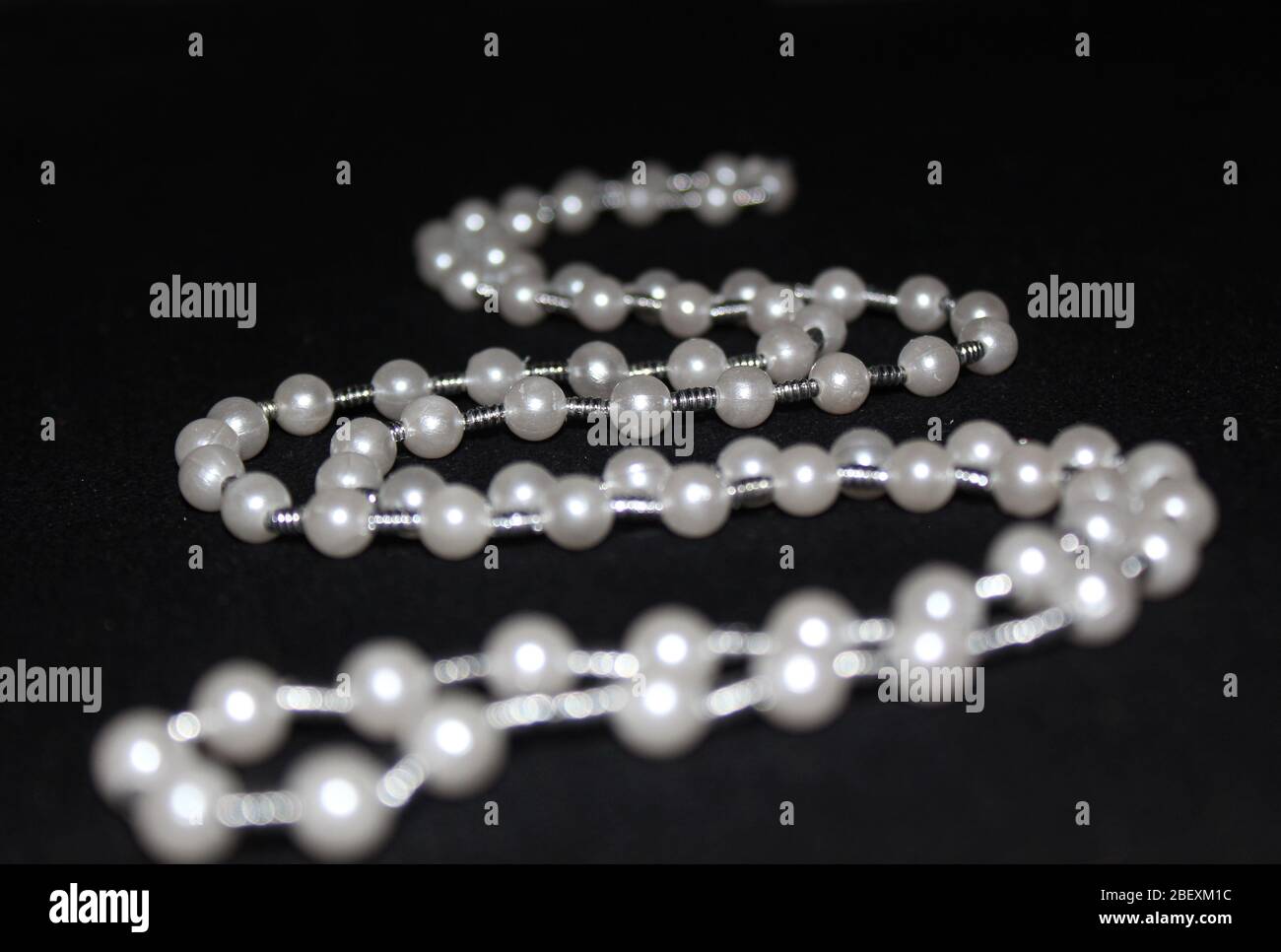 Pearl strings abstract background row of pearl ornaments on black ...