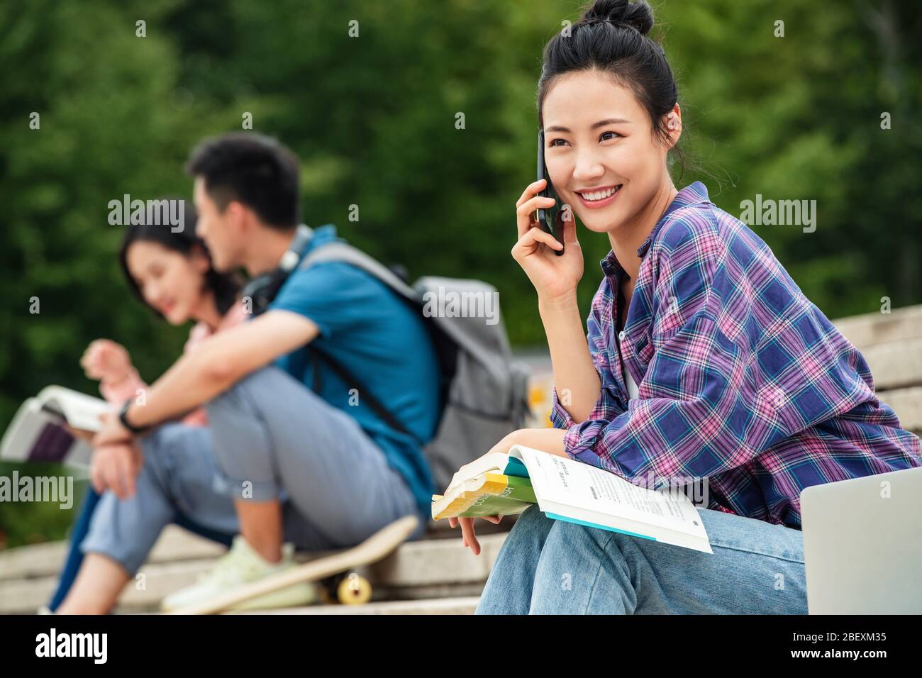 Happy college students sat on the steps of a call Stock Photo - Alamy