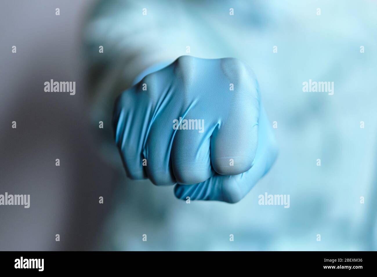 The Doctor In Blue Medical Gloves Shows A Fist A Symbol Of The Fight