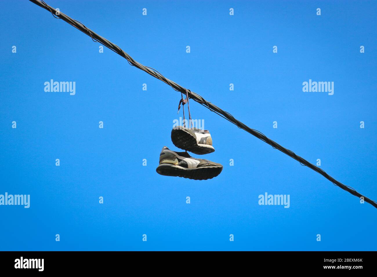 Sneakers hanging telephone wire hi-res stock photography and images - Alamy