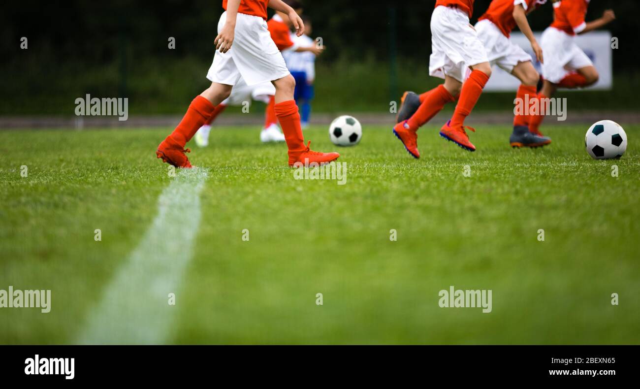 Football soccer team exercising with balls. Young athletes during the ...