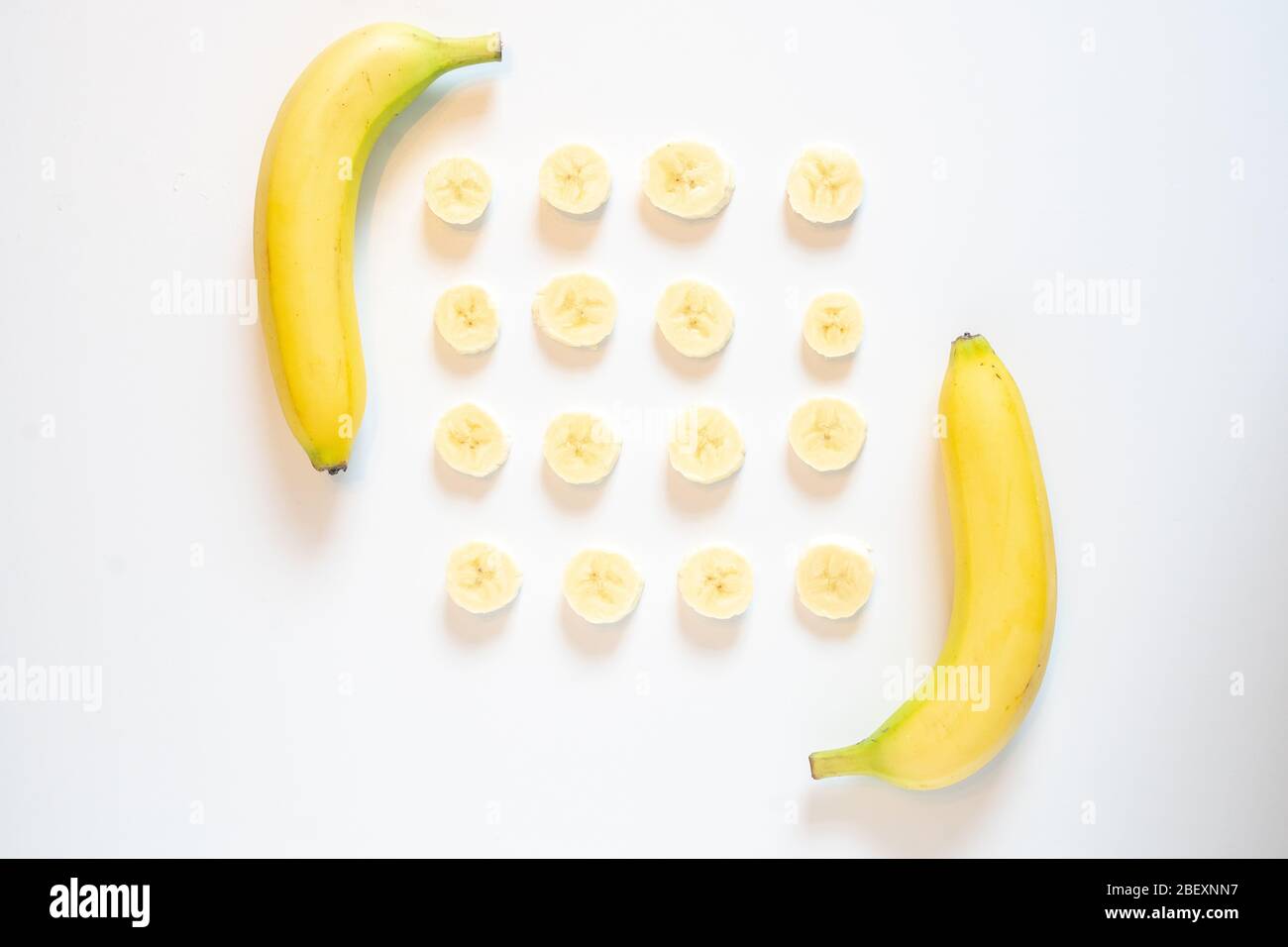An array of sliced banana pieces laid out in a square pattern with two ...
