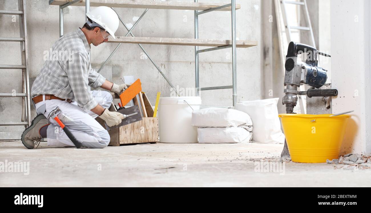 plasterer man construction worker work with tool box wear gloves, hard ...