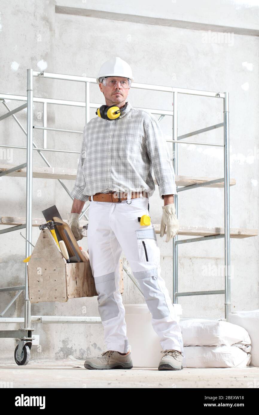 man construction worker holding tool box wear gloves, hard hat, glasses ...