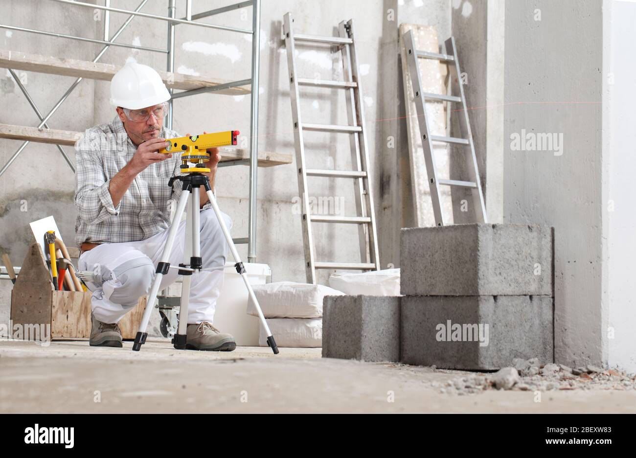 construction man worker measure with level laser wear hard hat and ...