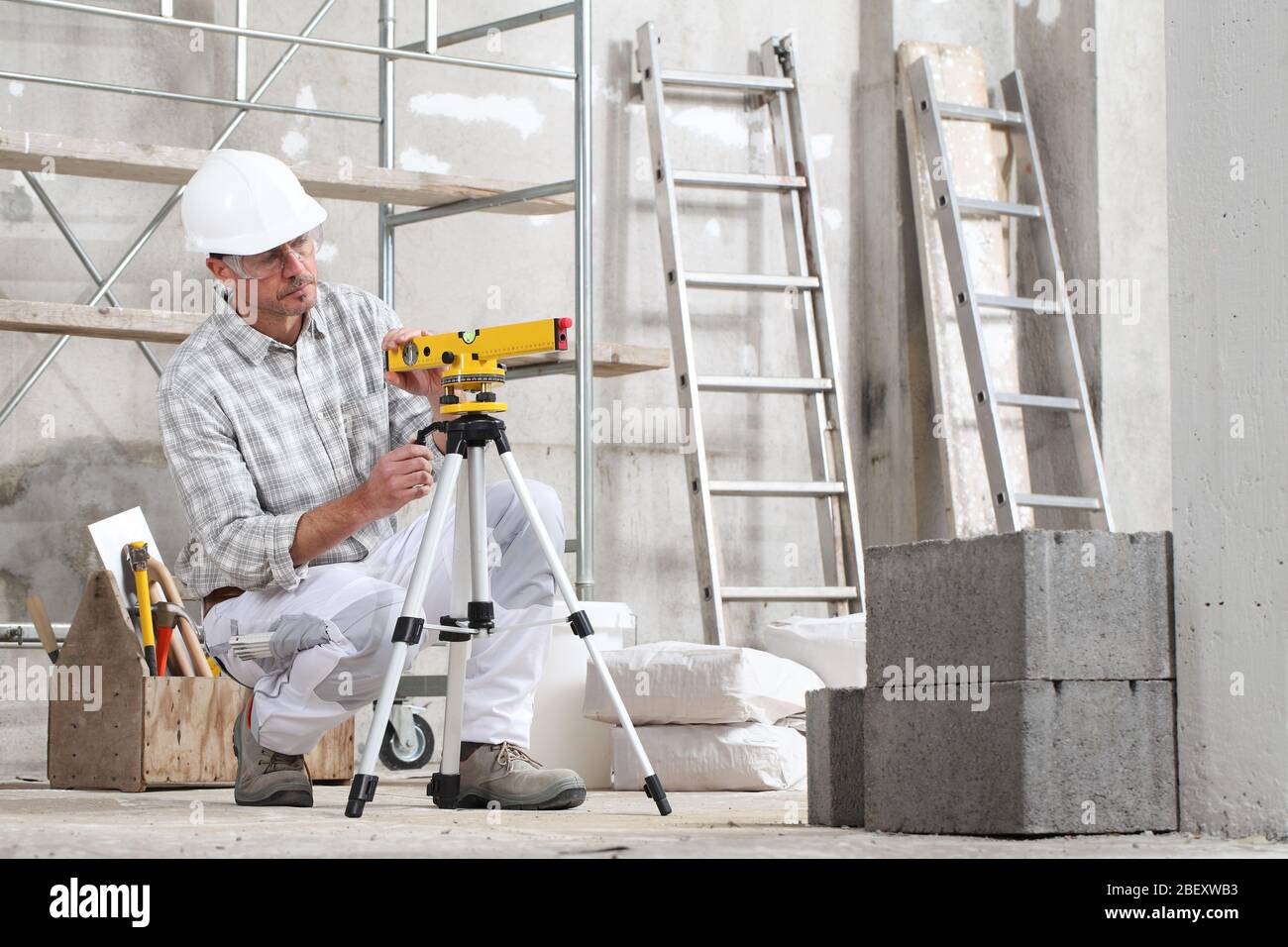 construction man worker measure with level laser wear hard hat and ...
