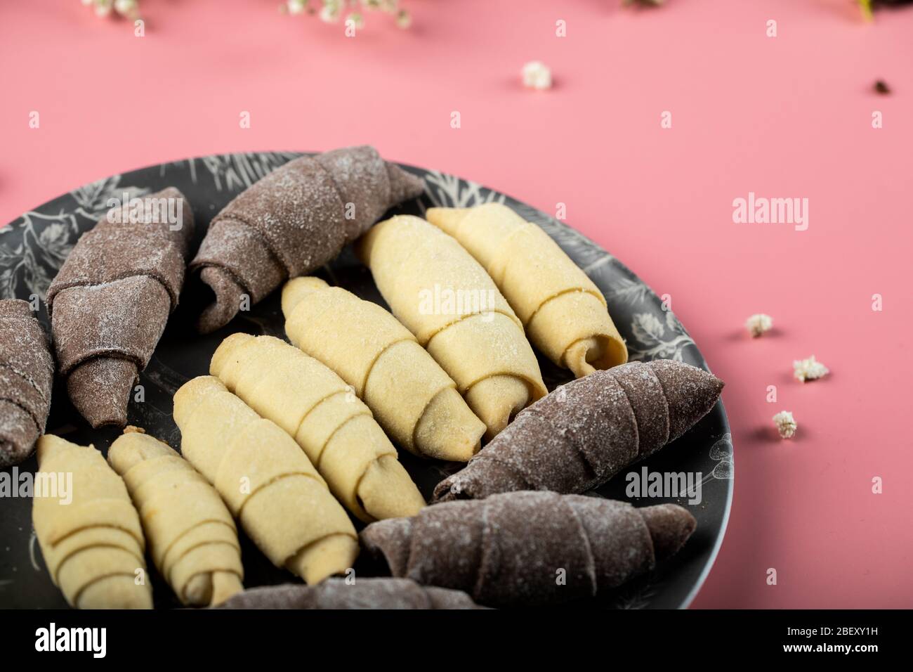 Traditional caucasian sweets mutaki with cocoa dough in a black platter ...