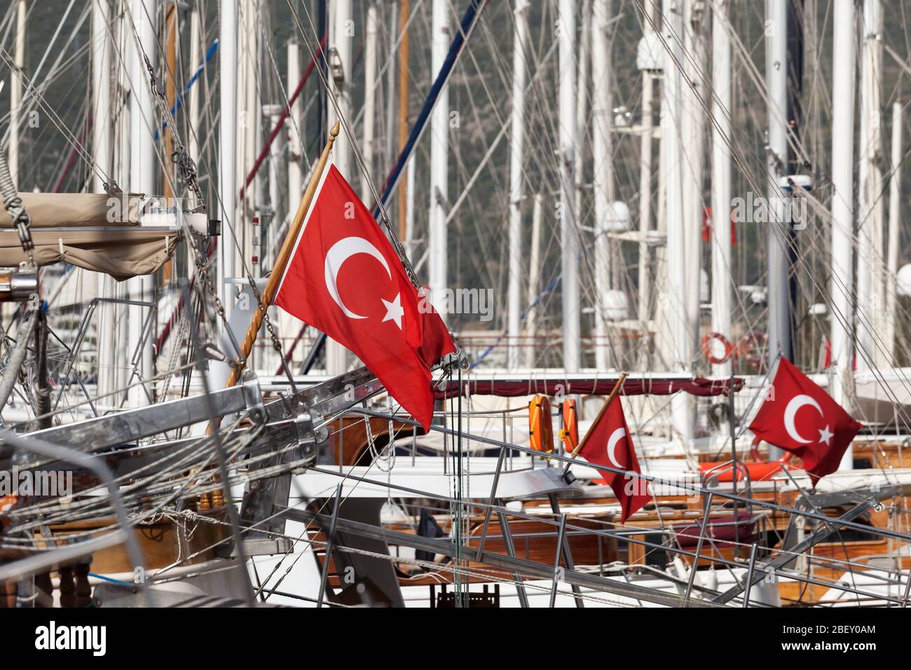 Red turkish flags with star and crescent sways in wind on mast of ...