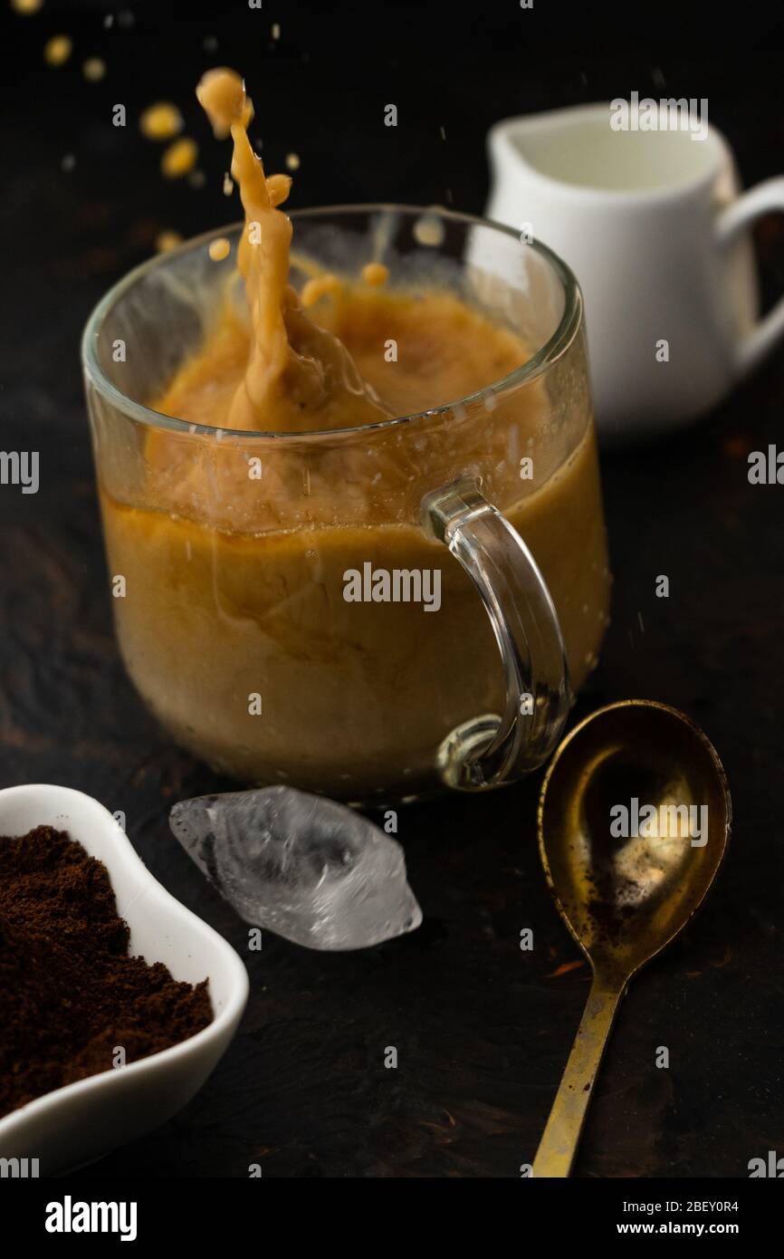 cold coffee with cream and ice, splash, splatter of coffee Stock Photo ...