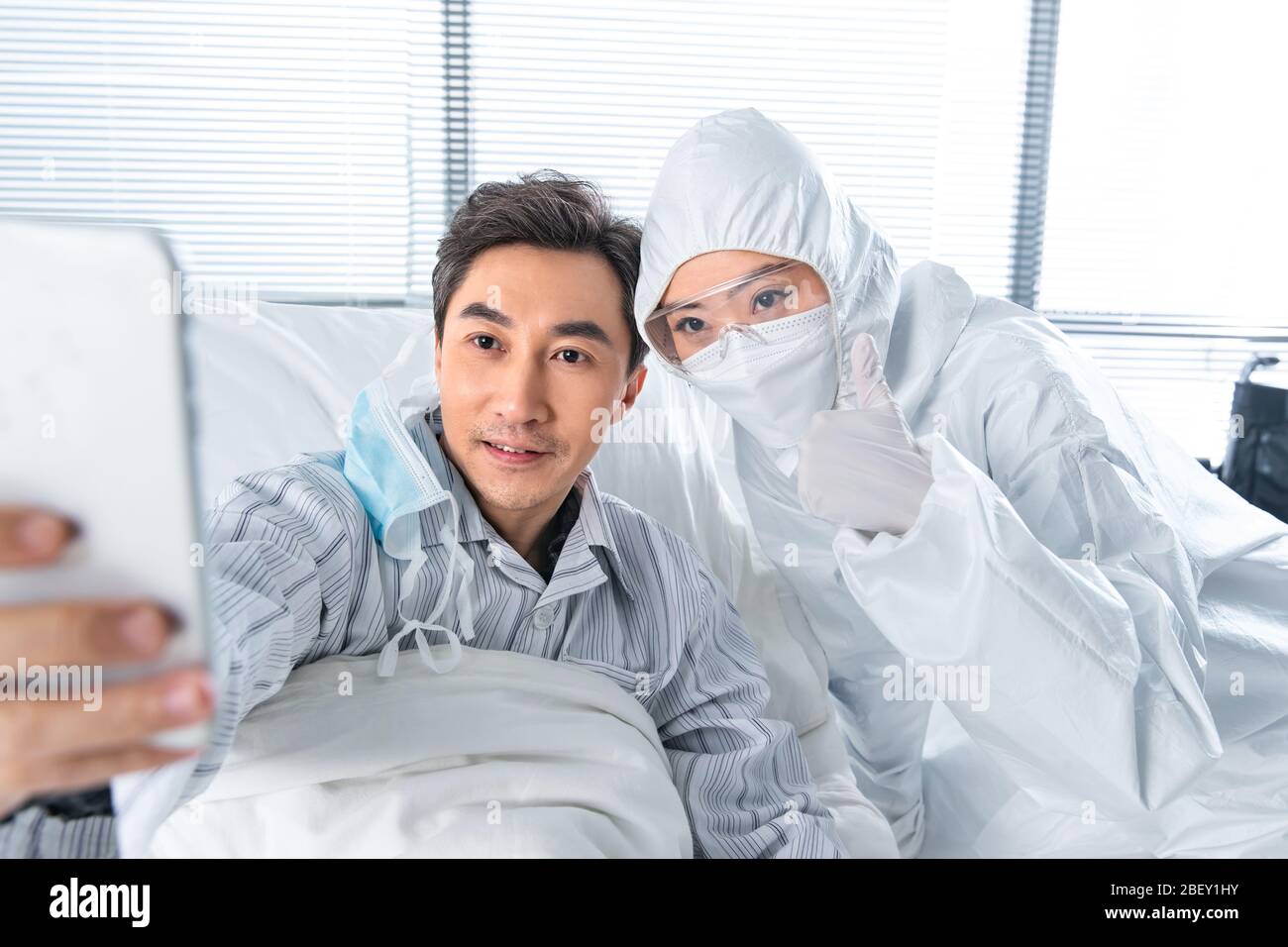 Doctors and patients to watch mobile phones Stock Photo - Alamy