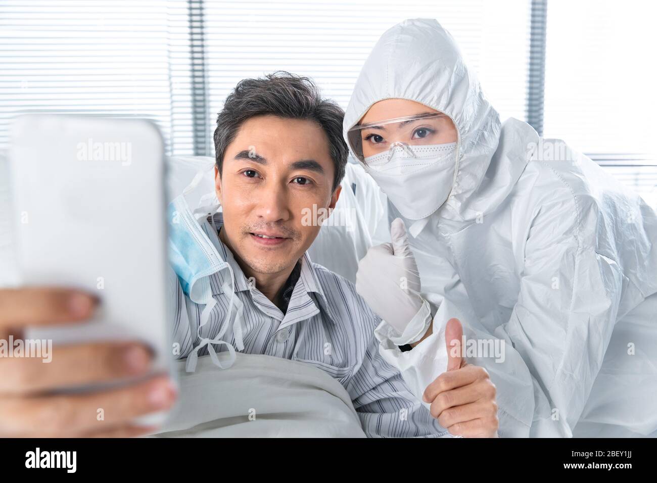 Doctors and patients to watch mobile phones Stock Photo - Alamy