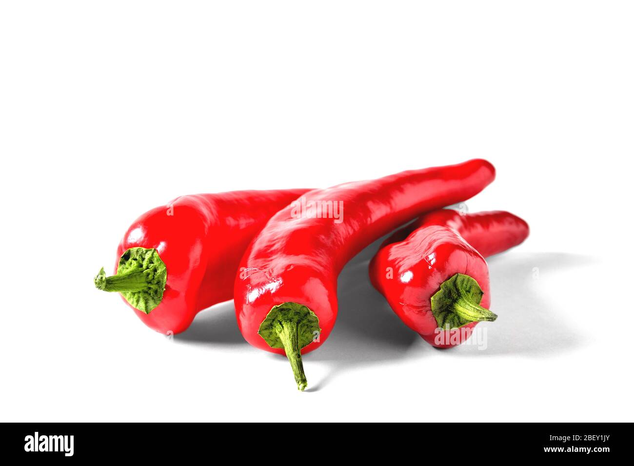 three red peppers elongated shape on white background, isolate Stock ...